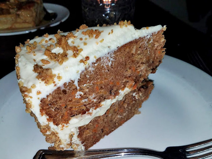 Carrot cake that's anything but garden variety! This towering slice promises layers of moist, spiced perfection with a generous frosting hug.