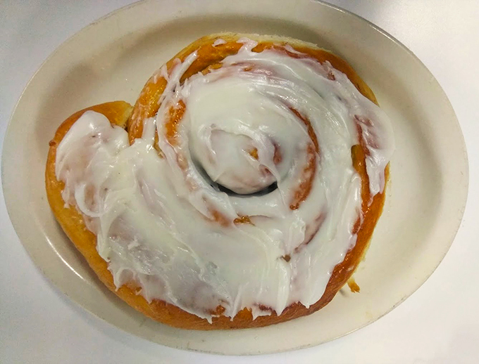 Ladies and gentlemen, I present to you the eighth wonder of the world: a cinnamon roll big enough to have its own zip code.