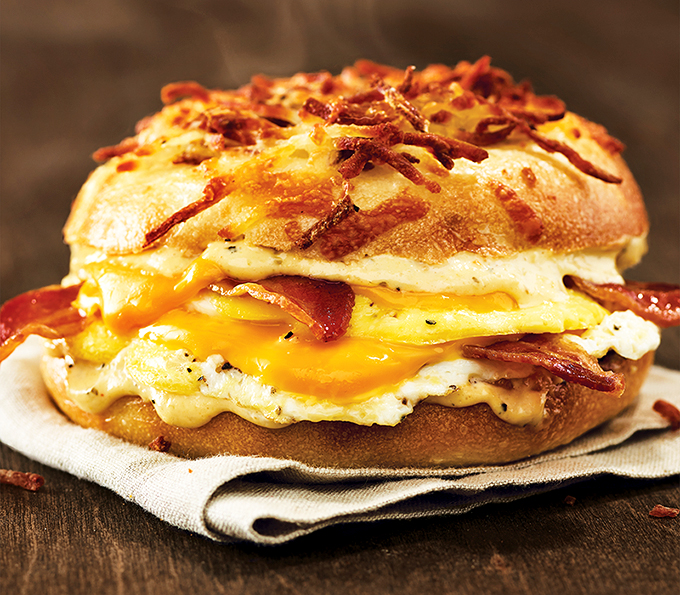Behold, the breakfast sandwich that puts your sad desk lunch to shame. It's a tower of morning glory that demands to be devoured.