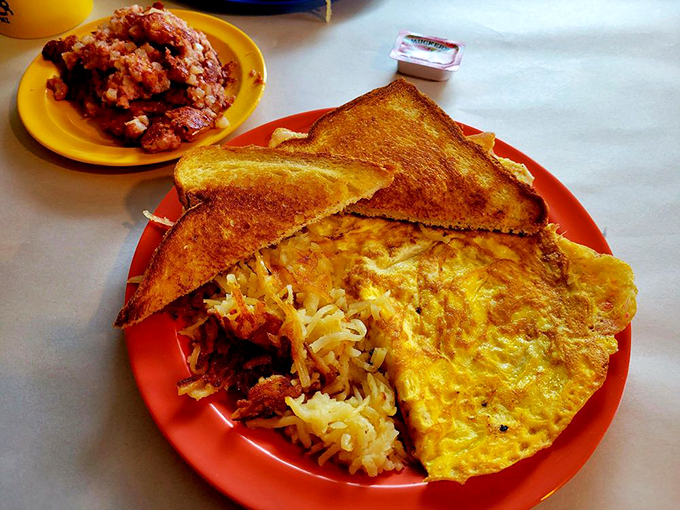 An omelet so fluffy it might float away, paired with hash browns that could make a potato proud. Breakfast of champions? You bet!