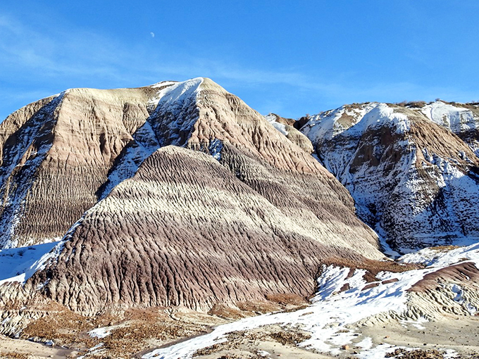 Winter in the badlands? It's like Mother Nature decided to frost her geological cake with a dusting of snow.