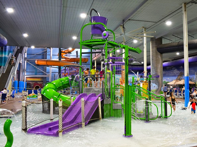 A vibrant purple and green water playground that looks like something Willy Wonka would design if he traded chocolate for splash zones.