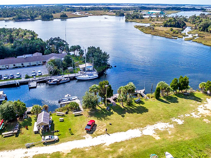 Where boats and dreams drift lazily along Florida's Nature Coast, this aerial view captures the perfect marriage of waterfront living and small-town charm.