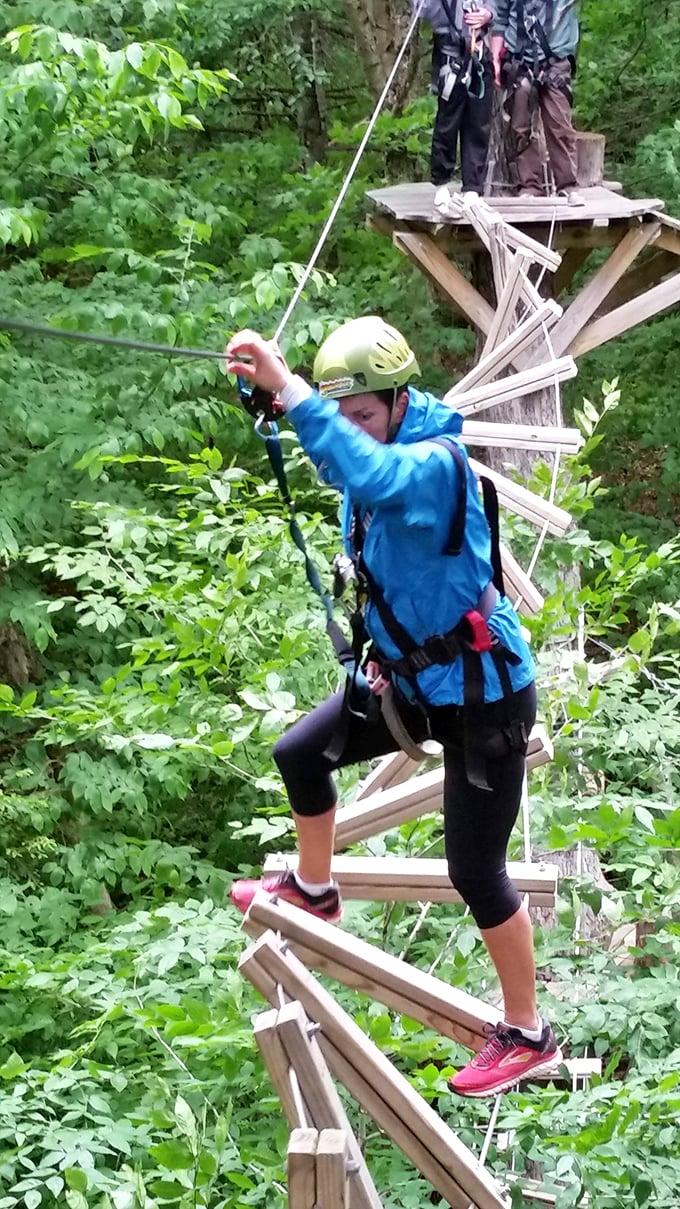 Leap of faith or leap of fun? At ArborTrek, it's both! This adventurer's graceful balancing act puts my couch-potato skills to shame.