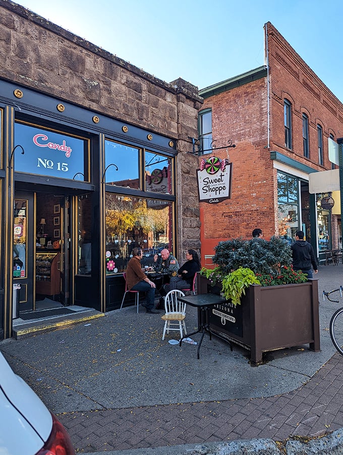 The Sweet Shoppe's charming exterior invites passersby to indulge in sugary delights. Its brick-and-stone facade and cozy outdoor seating area promise a nostalgic journey into a world of confectionery wonders.