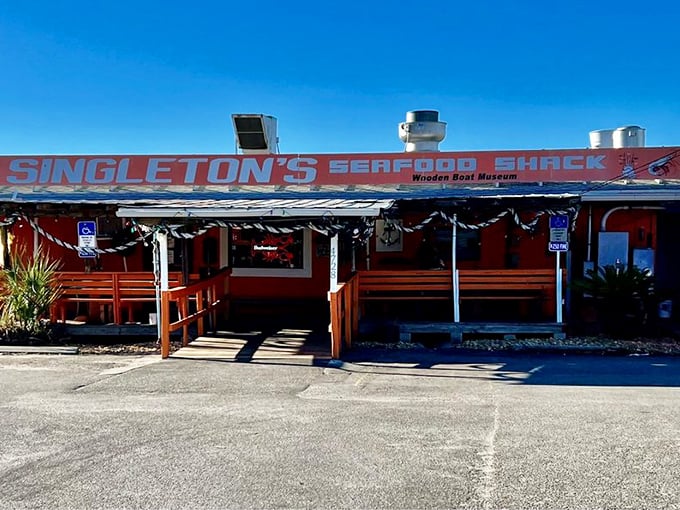 Sunshine or seafood? At Singleton's, you don't have to choose! This vibrant orange shack glows like a beacon for hungry sailors and landlubbers alike.