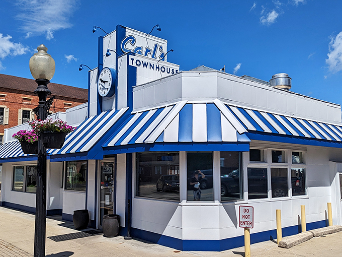 A slice of Americana, served with a side of nostalgia! Carl's Townhouse stands proud, its blue and white awning waving like a flag of deliciousness.