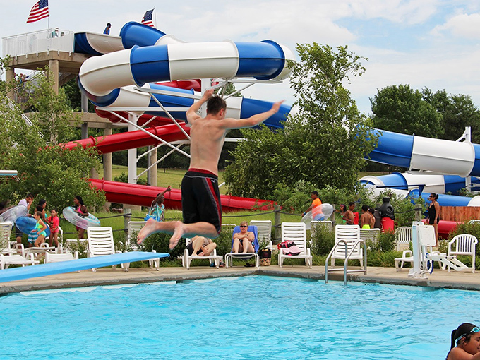Welcome to aquatic paradise! Pelican Harbor's lazy river meanders through lush greenery, promising a refreshing escape from the Illinois heat.