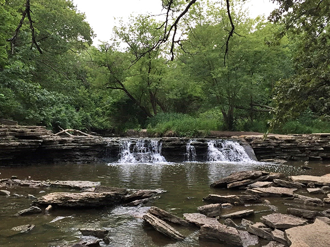Nature's own water park! Rocky Glen Waterfall cascades over layered rocks, creating a serene oasis that's more refreshing than a glass of iced tea on a hot summer day.