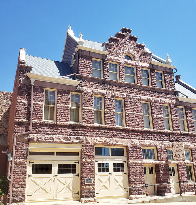 "Who needs a red carpet when you've got red stone?" This majestic pipestone building is the architectural equivalent of a power suit – impressive and unforgettable.