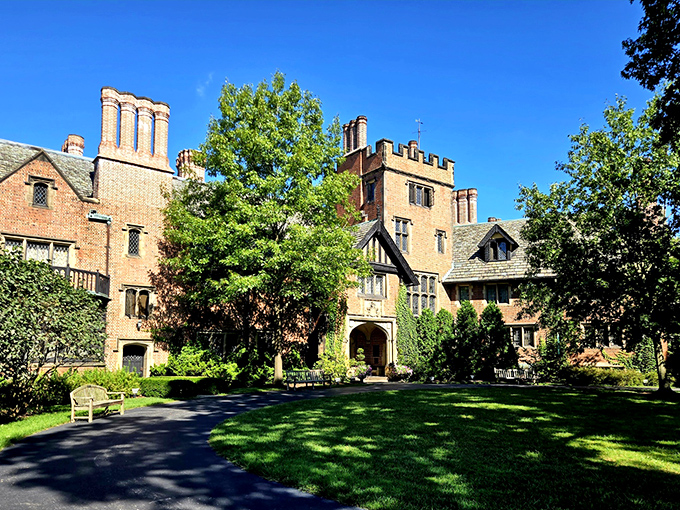 "Welcome to Downton Abbey's American cousin!" This Tudor Revival masterpiece whispers tales of Gilded Age glamour, with its imposing chimneys and manicured lawns fit for a garden party.