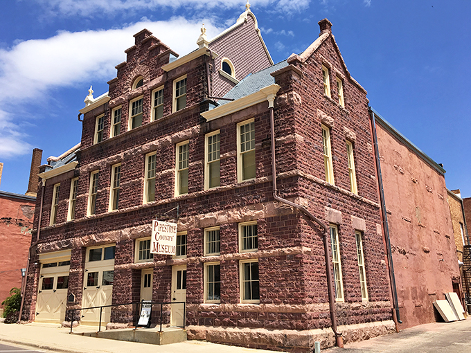 "Who needs a red carpet when you've got red stone?" This majestic pipestone building is the architectural equivalent of a power suit &ndash; impressive and unforgettable.