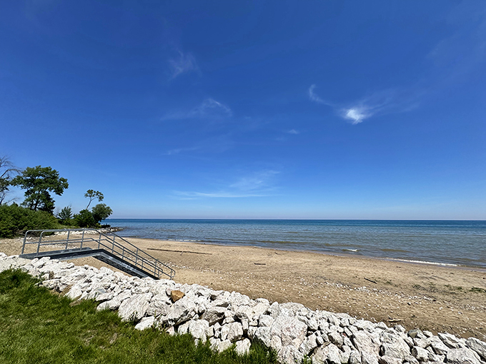 A slice of Lake Michigan paradise: Harrington Beach State Park's pristine shoreline invites visitors with its crystal-clear waters, sandy beach, and a sky so blue it seems to melt into the horizon.