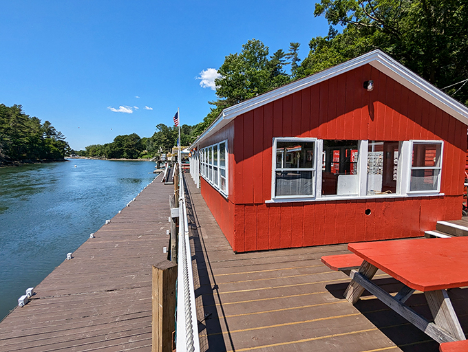 A postcard come to life! Chauncey Creek's cherry-red exterior pops against the serene waters, inviting seafood lovers to embark on a delicious adventure.