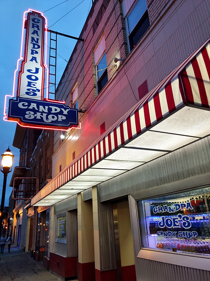 Step right up to the sweetest show in town! Grandpa Joe's neon sign beckons like a lighthouse for sugar-starved sailors, promising a voyage into confectionery bliss.