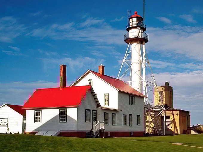A postcard come to life! Whitefish Point Lighthouse stands tall, its red-roofed keeper's quarters a cozy contrast to Lake Superior's vast expanse.