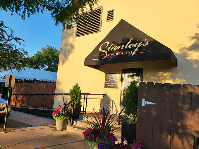 Welcome to flavor town! Stanley's exterior beckons like a yellow brick road leading to culinary oz, complete with a charming awning and blooming flower pots.