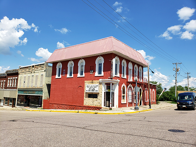 A crimson beacon of mystery, the Old Baraboo Inn stands proudly on the corner, inviting curious souls to step into a world where the past never truly fades away.
