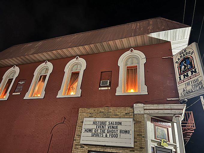 A crimson beacon of mystery, the Old Baraboo Inn stands proudly on the corner, inviting curious souls to step into a world where the past never truly fades away.