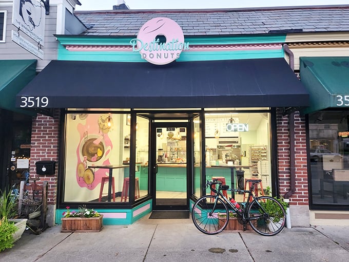 Welcome to donut paradise! Destination Donuts' cheerful storefront promises sweet adventures with its mint green and pink signage, beckoning sugar enthusiasts like a confectionery lighthouse.