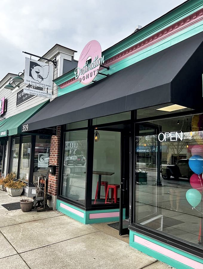 Welcome to donut paradise! Destination Donuts' cheerful storefront promises sweet adventures with its mint green and pink signage, beckoning sugar enthusiasts like a confectionery lighthouse.