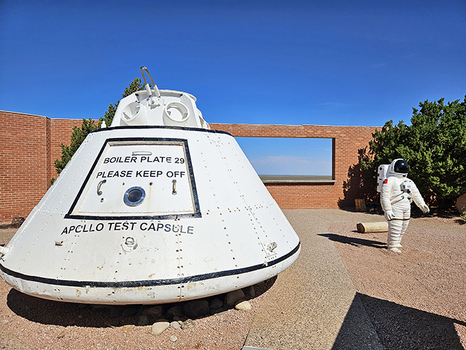 Space oddity: Apollo test capsule meets astronaut statue at Meteor Crater, where Earth's history collides with space exploration dreams.
