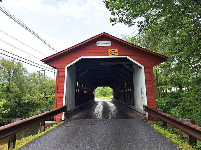 Step into a time machine, folks! This vibrant red gateway isn't just a bridge&mdash;it's a portal to Vermont's charming past.