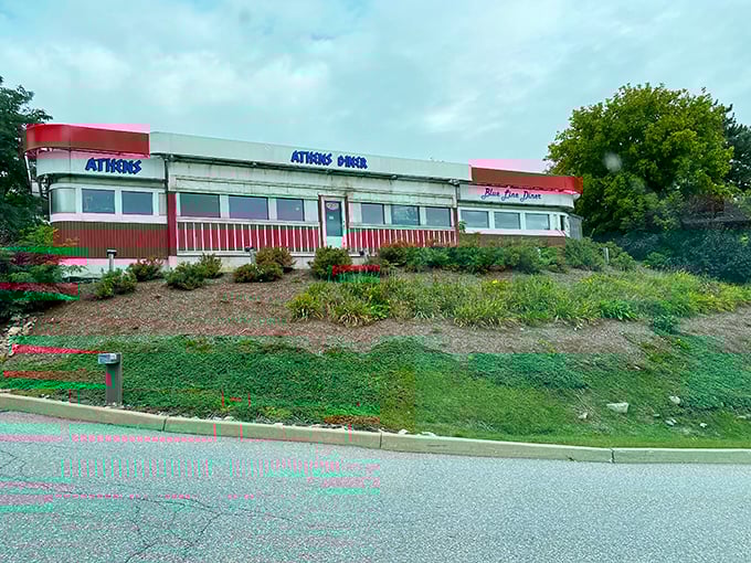 A slice of Americana with a Greek twist! Athens Diner stands proud, its red-trimmed exterior beckoning hungry travelers like a lighthouse for empty stomachs. 