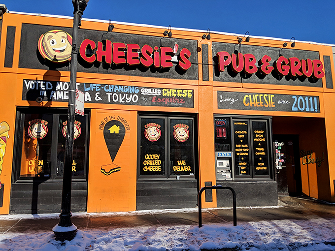 Welcome to cheese paradise! Cheesie's Pub & Grub's vibrant orange exterior is like a beacon for comfort food lovers, promising gooey delights within.