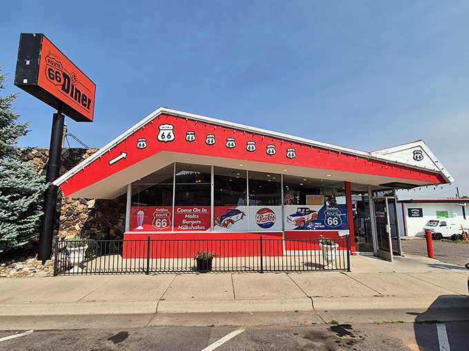 Route 66 meets retro heaven! This vibrant red diner beckons road-trippers and locals alike, promising a journey back to the golden age of American dining.