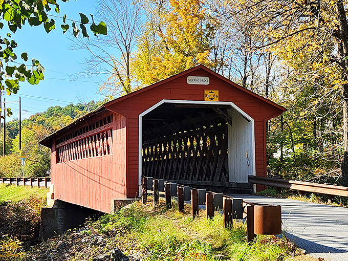 Step into a time machine, folks! This vibrant red gateway isn't just a bridge&mdash;it's a portal to Vermont's charming past.
