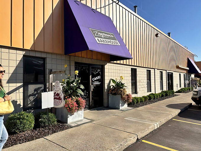 Welcome to carb heaven! Zingerman's Bakehouse greets you with a cheerful purple awning, promising a world of delicious treats inside.