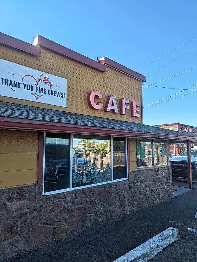 "Welcome to flavor town!" This sun-drenched diner facade promises comfort food and small-town charm, with a heartwarming nod to local heroes.