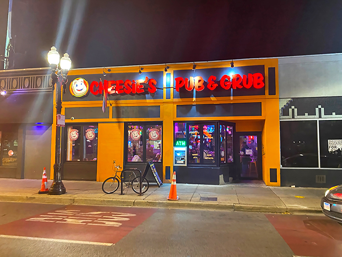 Welcome to cheese paradise! Cheesie's Pub & Grub's vibrant orange exterior is like a beacon for comfort food lovers, promising gooey delights within.