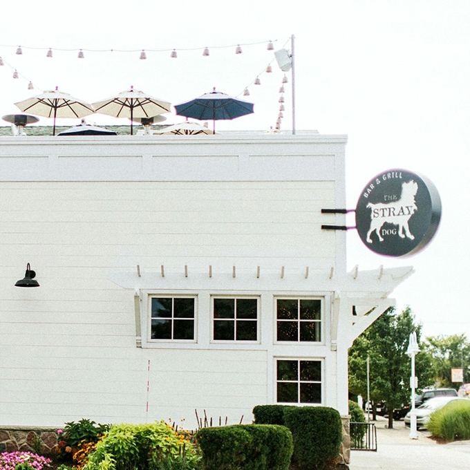 A beacon of culinary delight! The Stray Dog's charming exterior promises a feast for the senses, with its rooftop umbrellas hinting at the elevated experience awaiting inside.