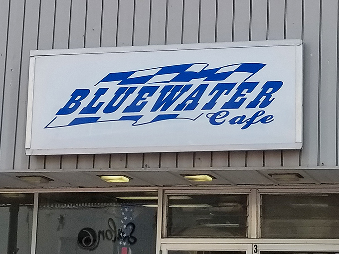 A sign that says "come on in" without saying a word. Bluewater Cafe's exterior promises a classic diner experience with a dash of small-town charm.