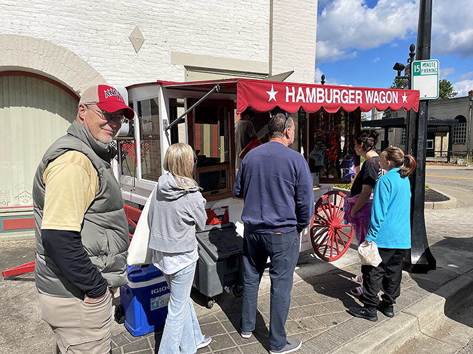 Step right up to the time-traveling taste sensation! The Hamburger Wagon's bright red awning beckons hungry patrons like a culinary Bat-Signal for burger lovers.
