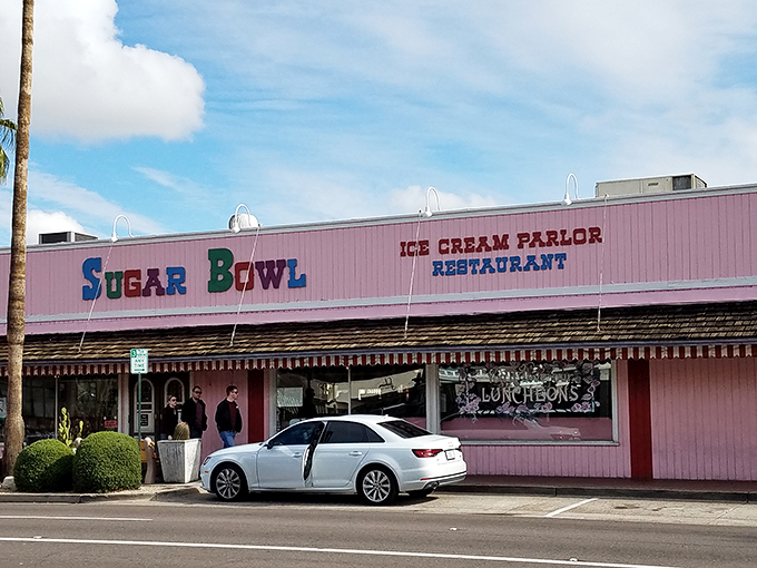Palm trees and pink paradise! The Sugar Bowl's exterior is like a retro postcard come to life, beckoning you to step into a sweeter era.