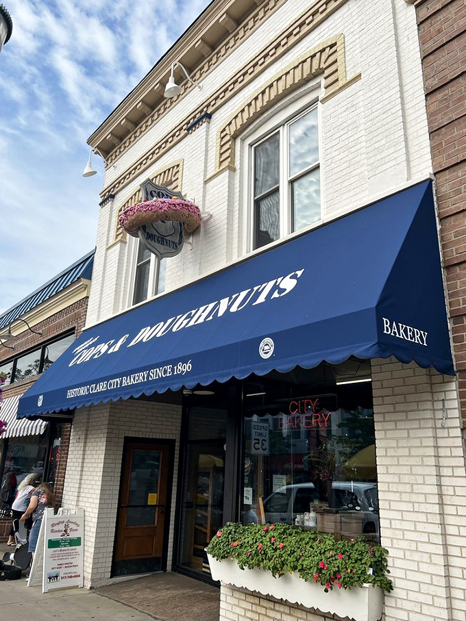 A blue awning beckons like a siren's call, promising sweet delights within. This historic bakery's facade is as inviting as the aroma of fresh donuts wafting through the air.