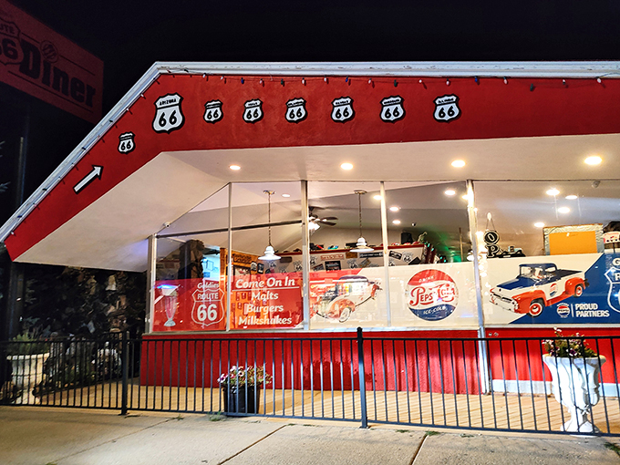 A slice of Route 66 nostalgia: Goldies Diner lights up the night with its iconic red awning and vintage signage, inviting travelers to step back in time for a classic American dining experience.