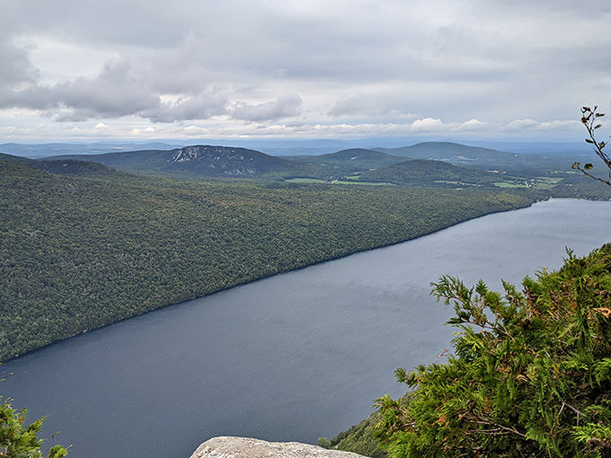 Nature's masterpiece unfolds: Lake Willoughby nestled between mountains, a sight that'll make you forget your smartphone exists.