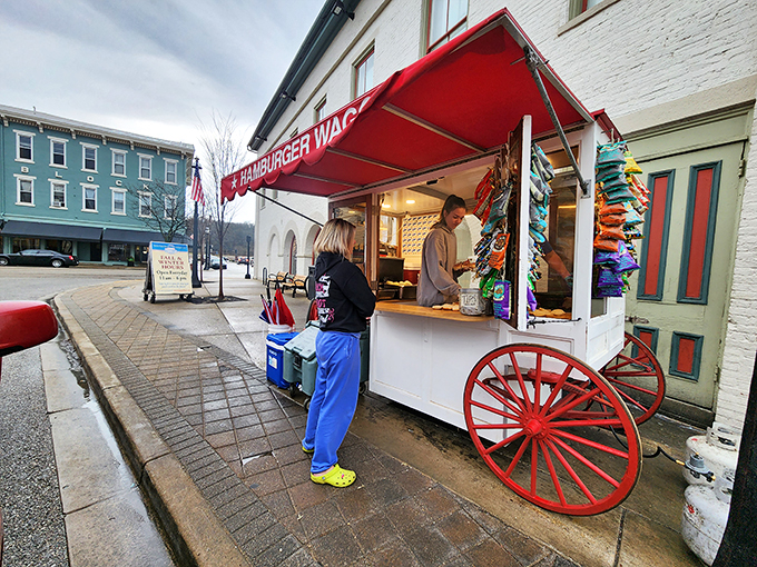 Step right up to the time-traveling taste sensation! The Hamburger Wagon's bright red awning beckons hungry patrons like a culinary Bat-Signal for burger lovers.