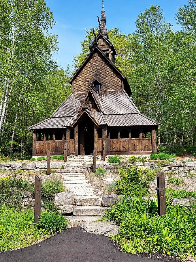 A woodland wonder! This Norse-inspired church stands tall, its dark wood a striking contrast against the vibrant green foliage. Middle Earth meets the Midwest in this architectural marvel.