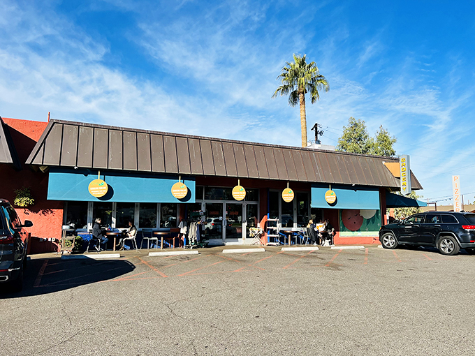 Sun-soaked charm: La Grande Orange Grocery & Pizzeria welcomes diners under Arizona's blue skies, where palm trees and good eats meet.