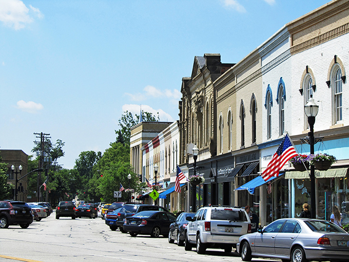 Main Street magic: Where Norman Rockwell meets Mayberry, with a dash of modern charm. American flags flutter proudly as shoppers stroll past quaint storefronts, creating a scene straight out of a nostalgic daydream.