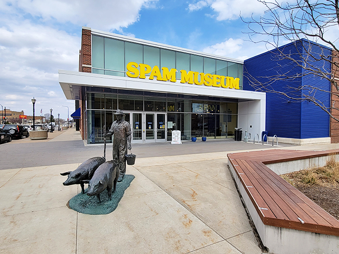 Welcome to pork paradise! The SPAM Museum's exterior beckons with its bold yellow sign and quirky pig statues, promising a meaty adventure inside.