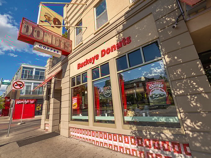 A beacon of hope for the hungry! Buckeye Donuts' retro sign promises sweet salvation 24/7, like a lighthouse guiding sugar-starved ships to shore.