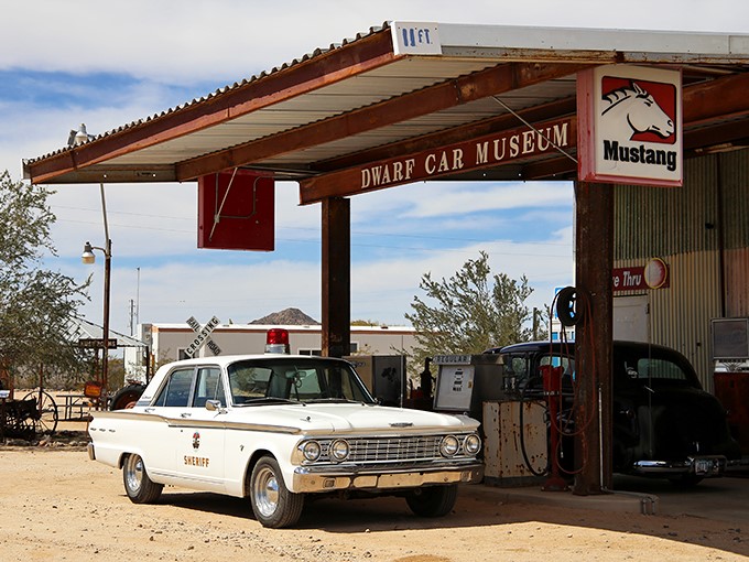 Welcome to the land of automotive dreams! This vintage gas station facade sets the stage for a journey through time and tiny cars.