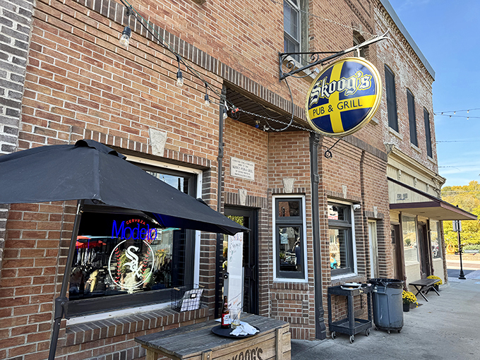 Welcome to flavor town! Skoog's Pub & Grill's inviting exterior promises a feast for the senses, with its charming brick facade and Swedish-inspired sign beckoning hungry travelers.