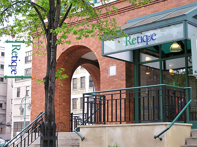 Welcome to Retique, where fashion dreams come true without breaking the bank! This charming brick facade with its inviting green awning is like a siren call to savvy shoppers.